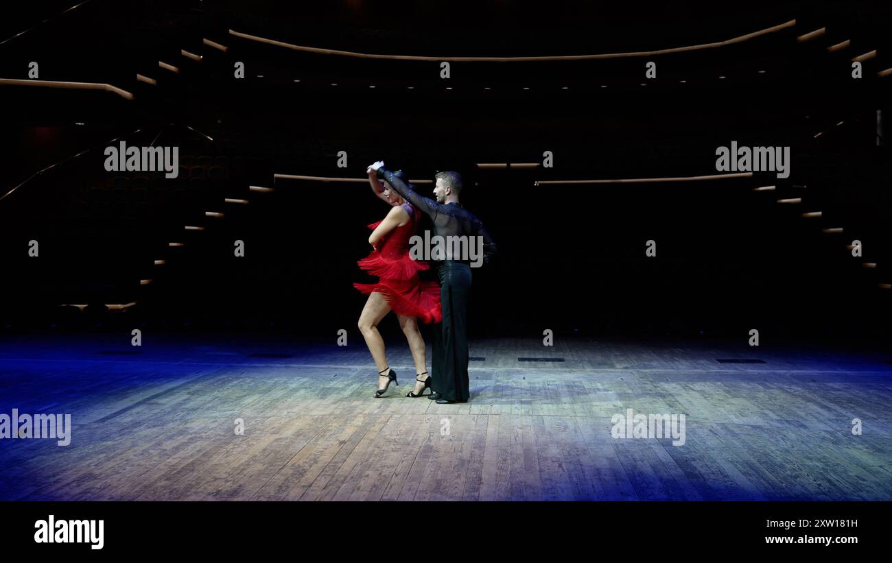 Feet closeup of Argentinian tango dancer in a red dress. Ballroom ...