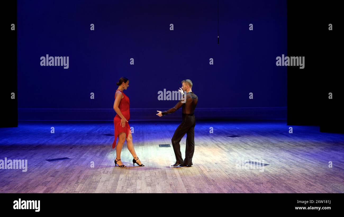 Feet closeup of Argentinian tango dancer in a red dress. Ballroom ...