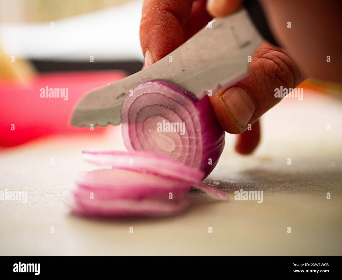 Cutting red onions in preperation of a bbq Stock Photo - Alamy