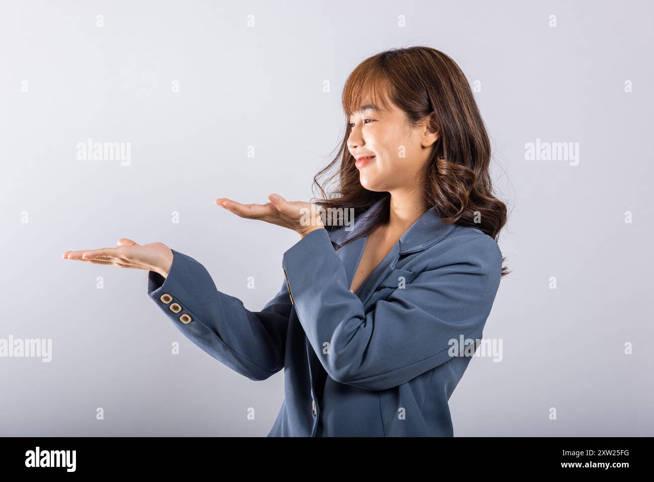 Asian happy portrait beautiful cute young woman smile standing presenting product holding ...