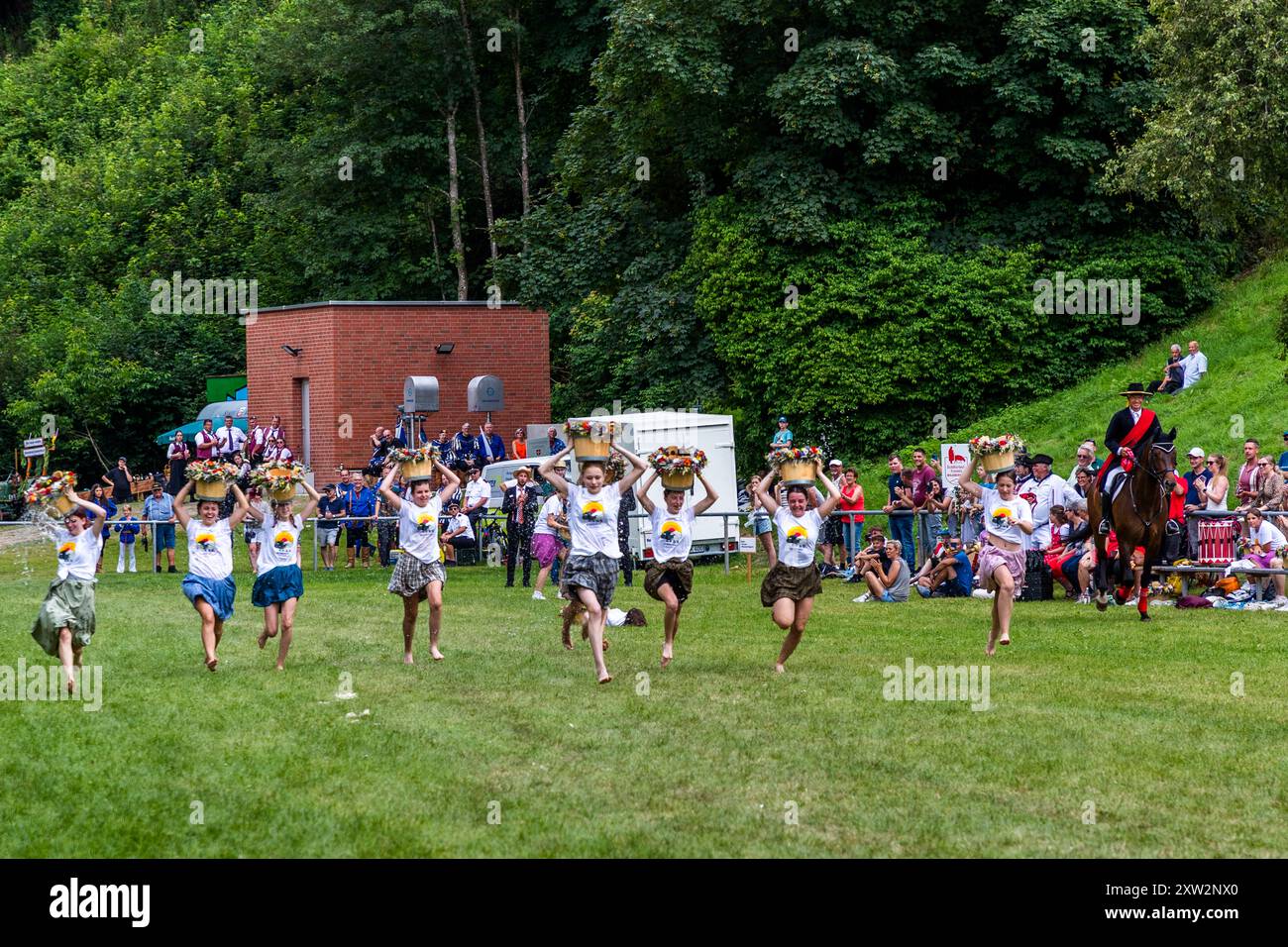 Schoolgirls in the water bucket race. In the race, young women from the ...