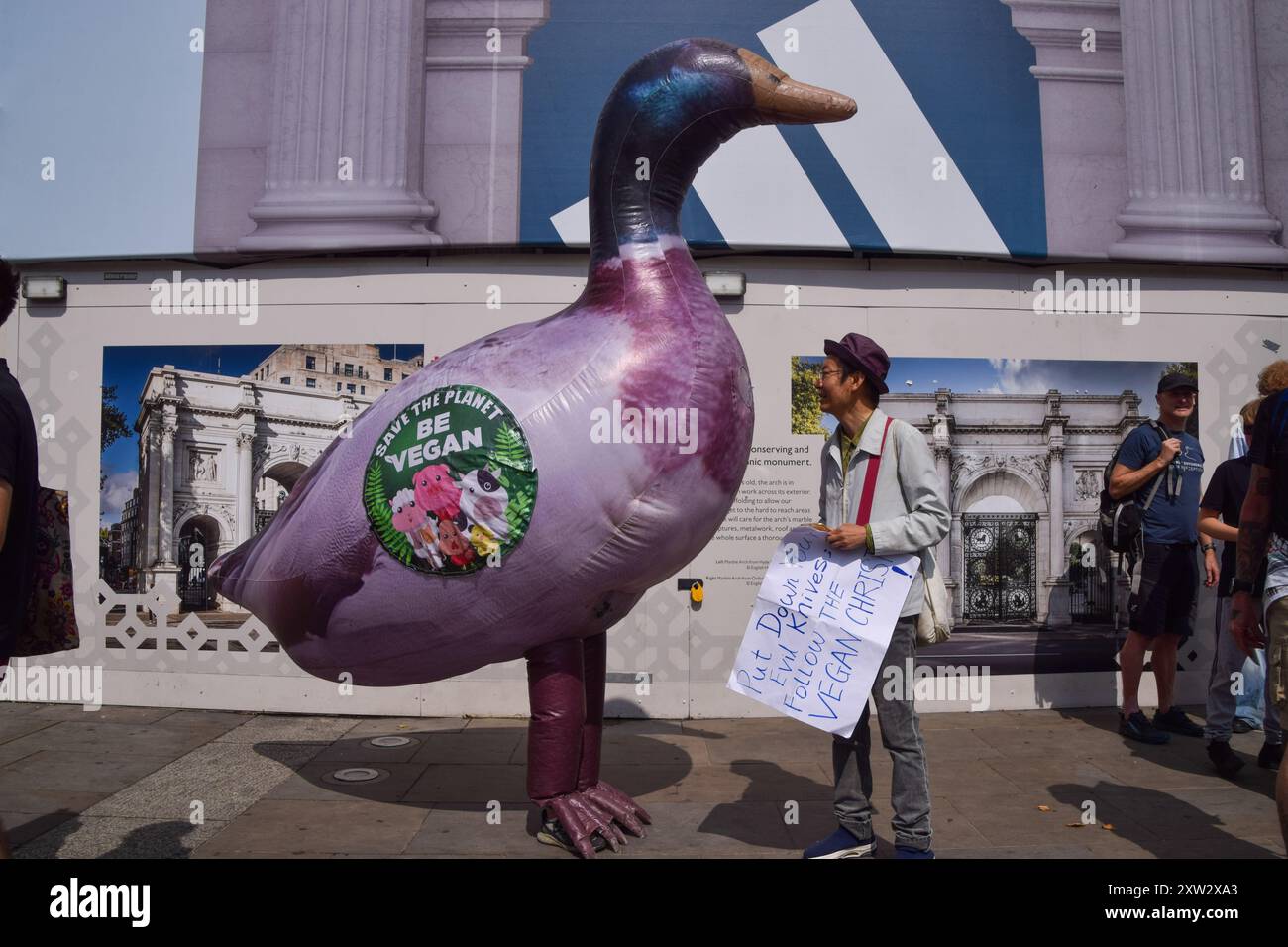 August 17, 2024, London, England, UK: A protester wears a giant ...