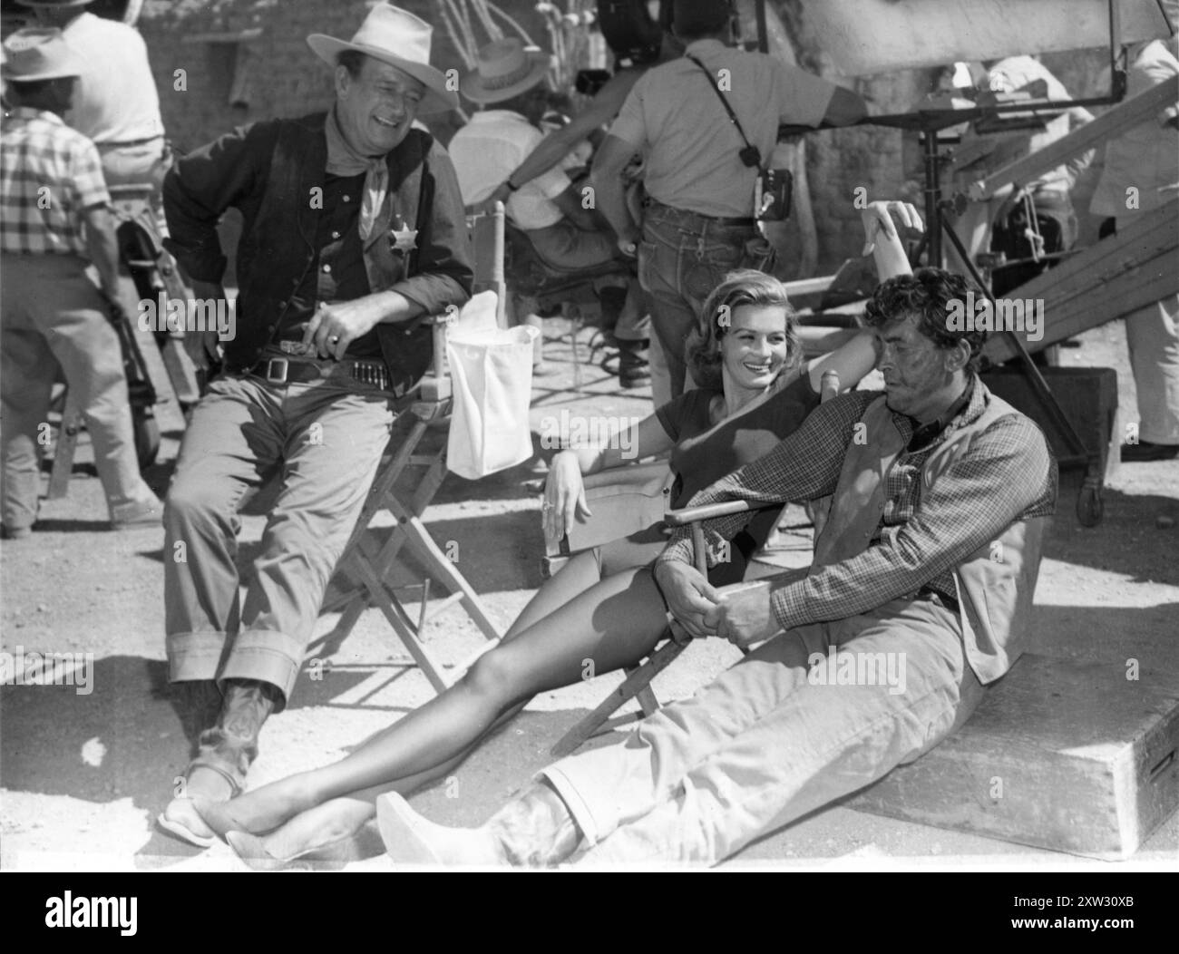 JOHN WAYNE, ANGIE DICKINSON and DEAN MARTIN relaxing between scenes on ...