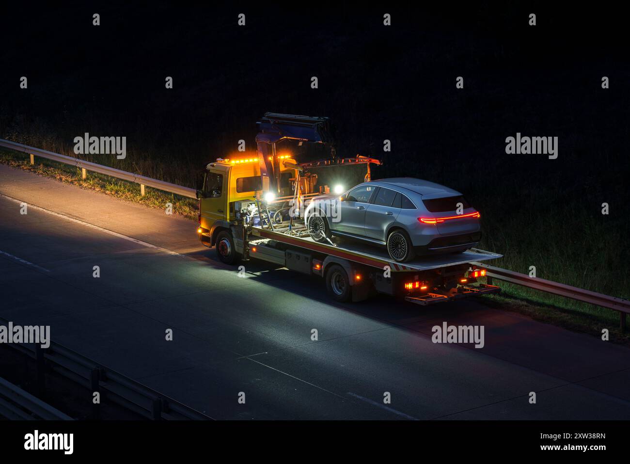 car rescue transports a troubled luxury car towing truck during works ...
