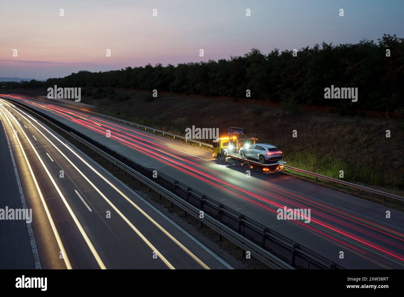 car rescue transports a troubled luxury car towing truck during works ...
