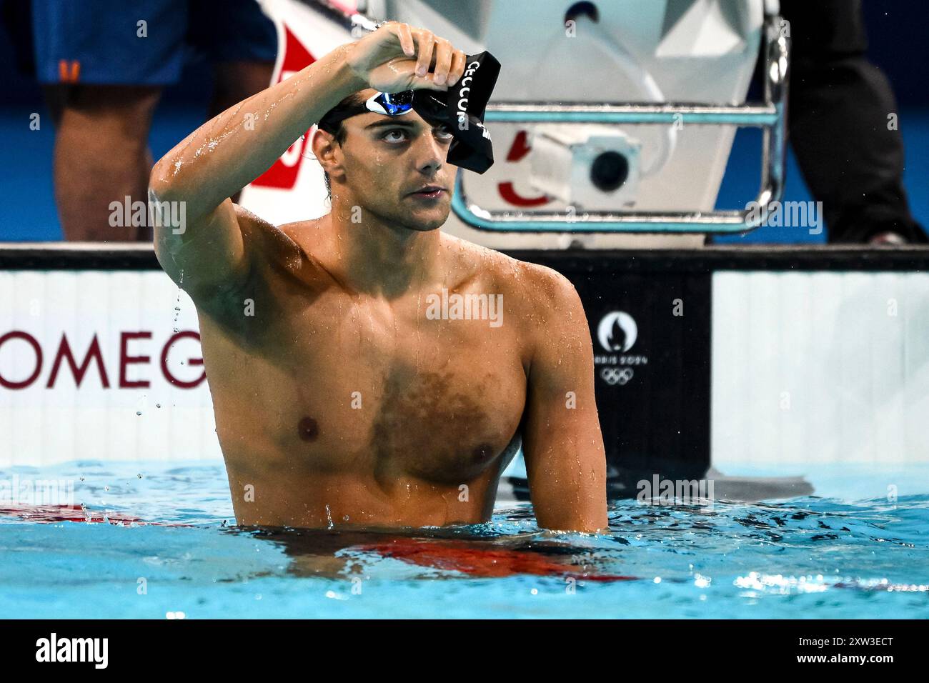 Thomas Ceccon of Italy holds his cap after winning the gold medal in the swimming 100m ...