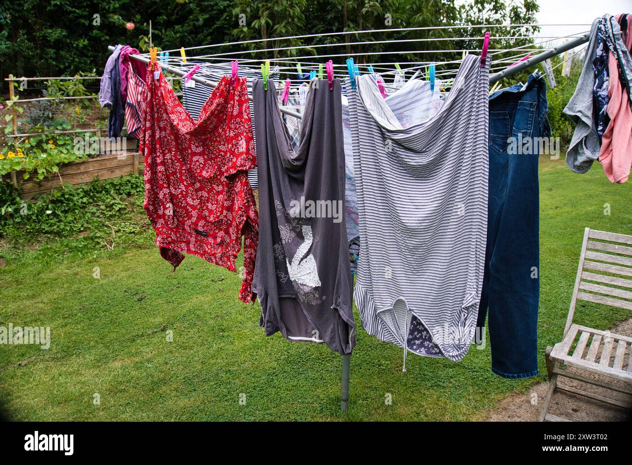 Clothes hanging out to dry on a rotary clothes dryer in a garden Stock ...