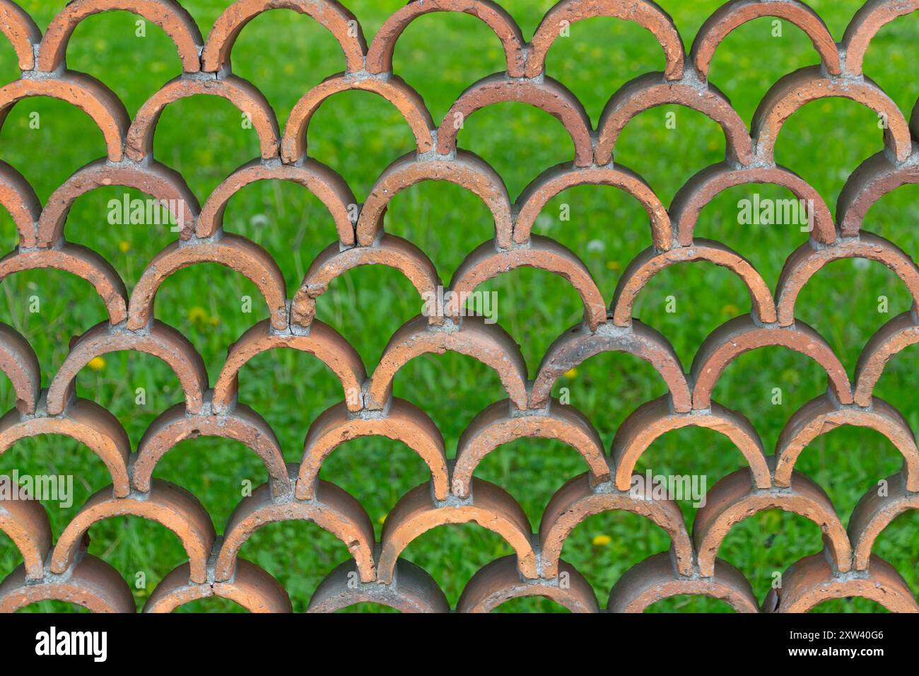 Decorative fence made of semicircular bricks, arranged in a staggered ... Decorative fence made of semicircular bricks, arranged in a staggered ...