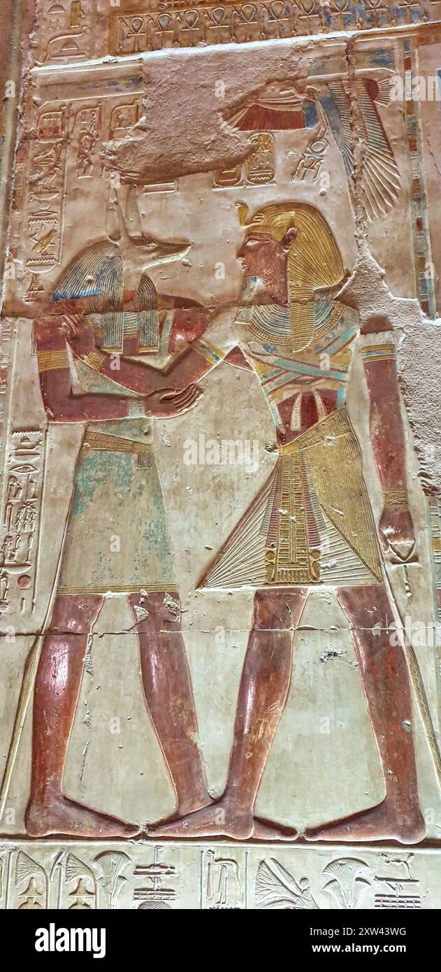 Painted wall relief of Pharaoh Seti I receiving the mummification god ...