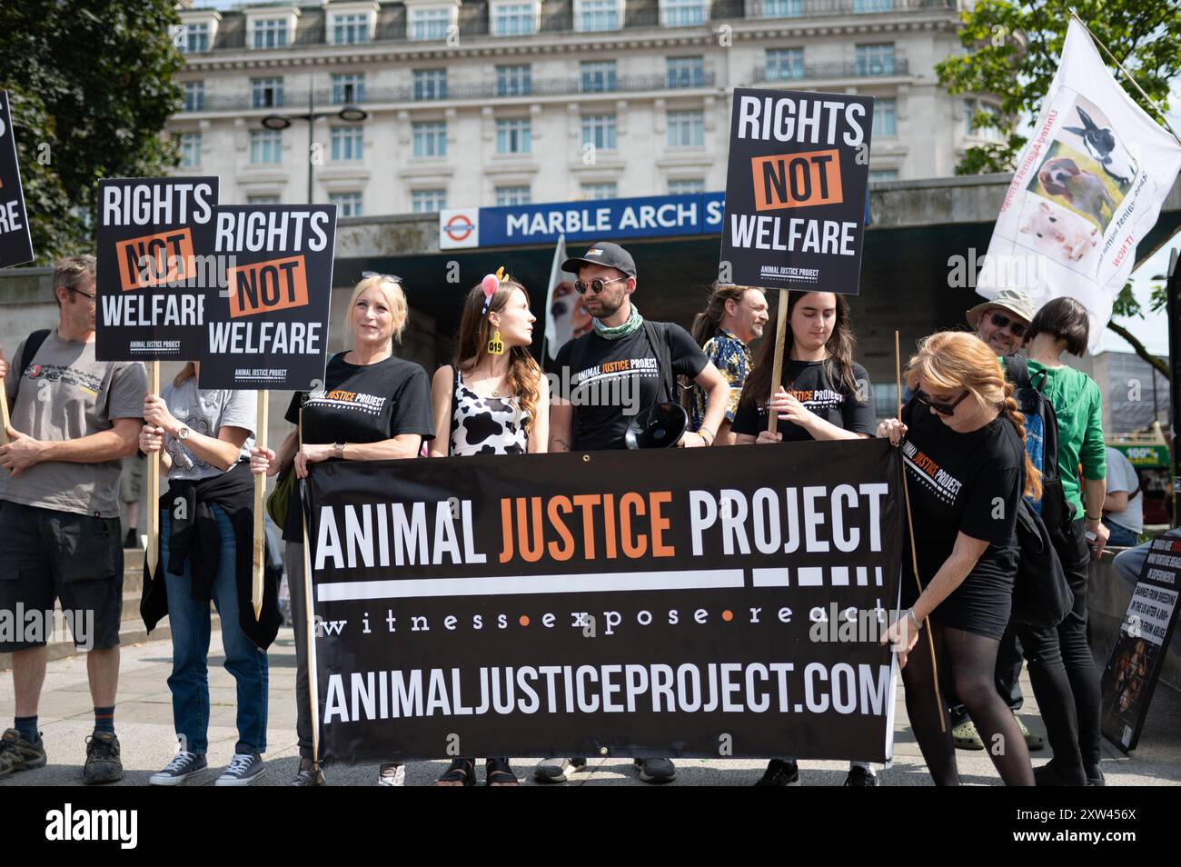 Demonstrators holding a banner and placards gather outside Marble Arch ...