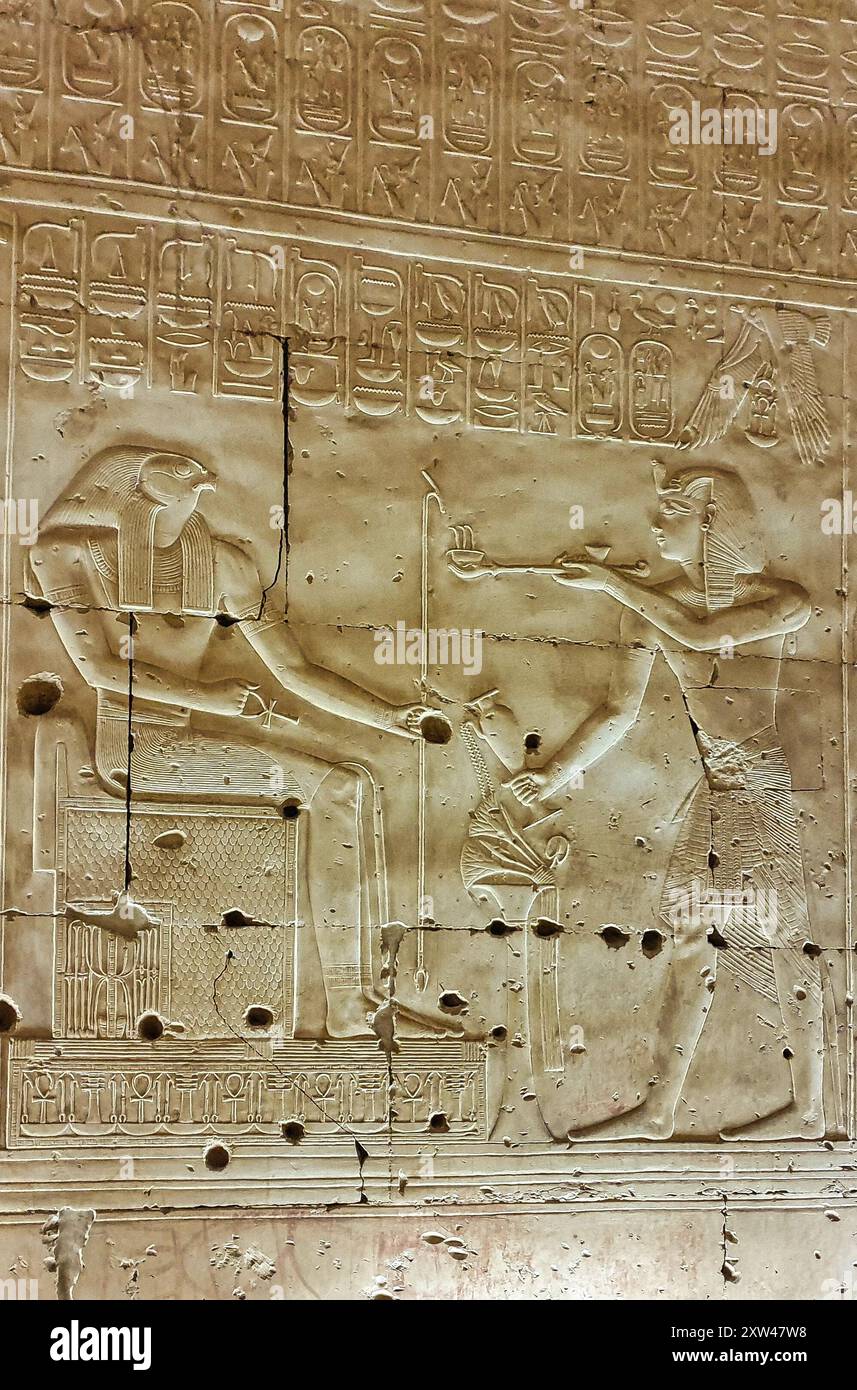 Pharoah Seti I makes incense offerings to a seated form of God Horus in ...