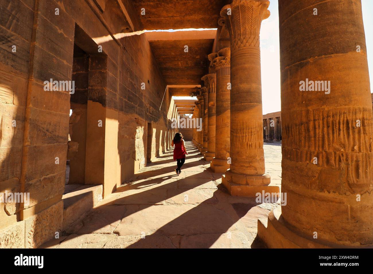 A visitor walks down the beautiful collonades in the courtyard in the ...
