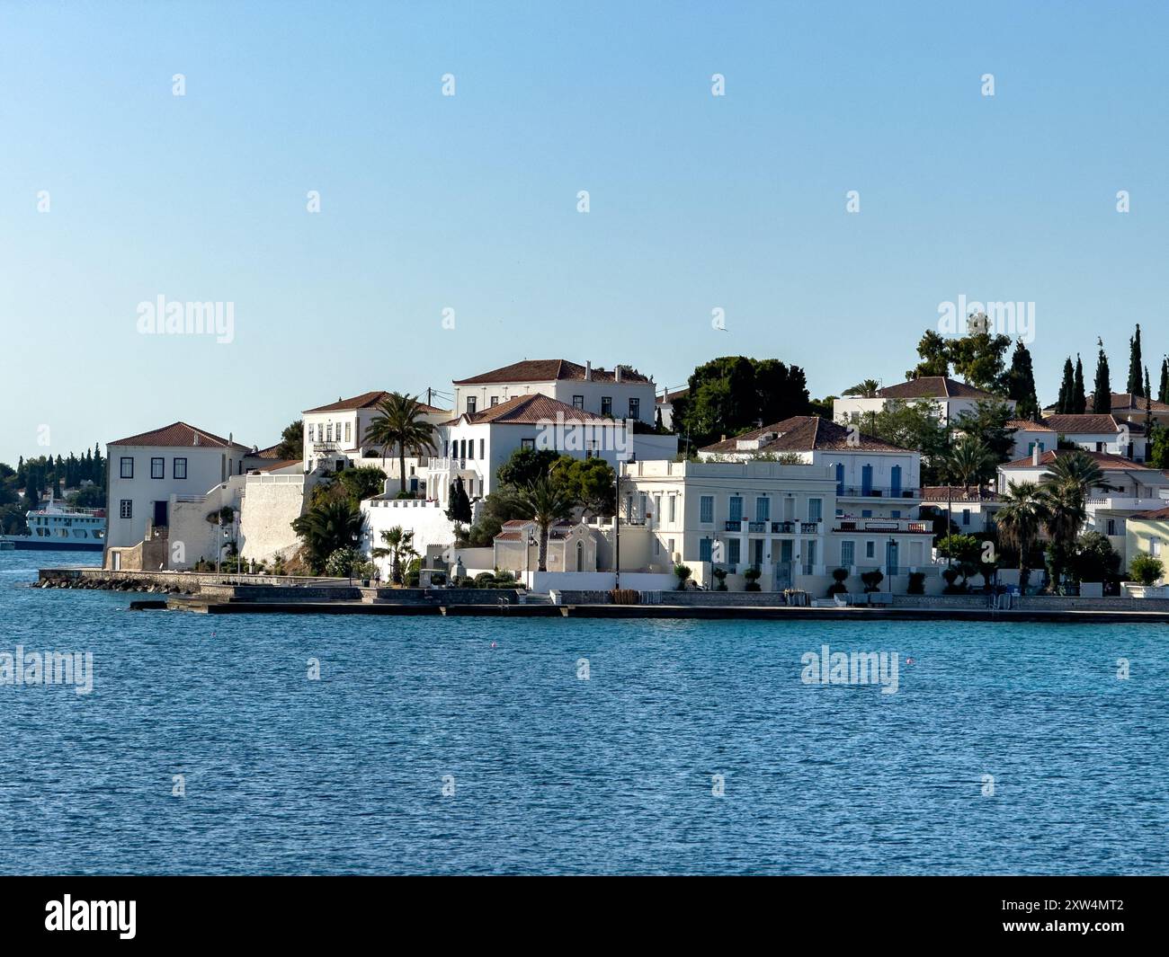 Spetses island, Greece. Seafront neoclassical buildings and Saint Mamas ...