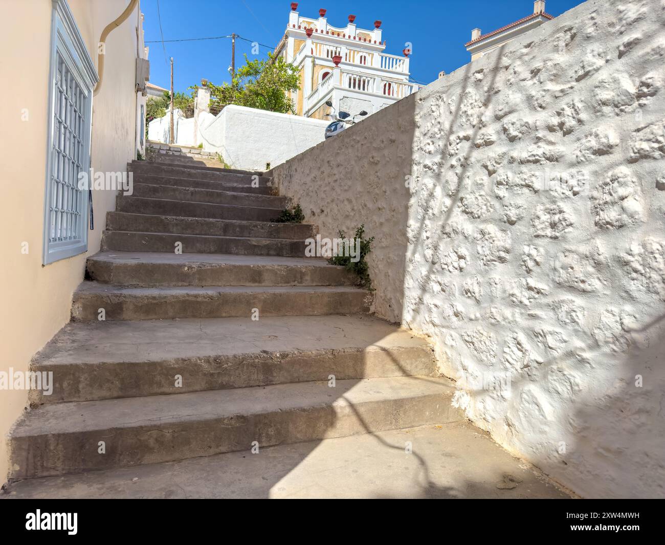 Greece, Spetses island, stairs and stone walls at the old town, blue ...