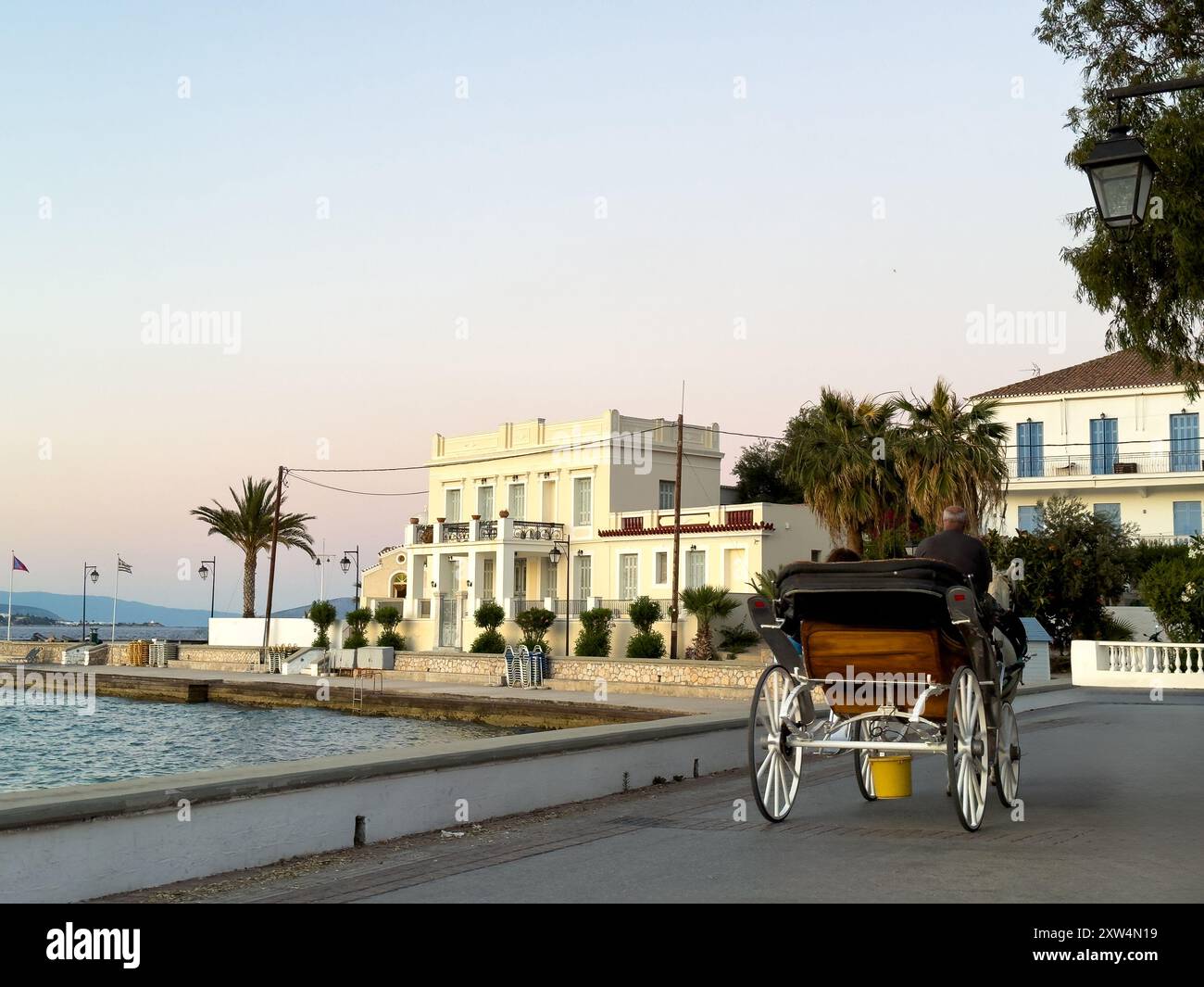 Spetses island, Greece. Horse carriage rear view and promenade at old ...