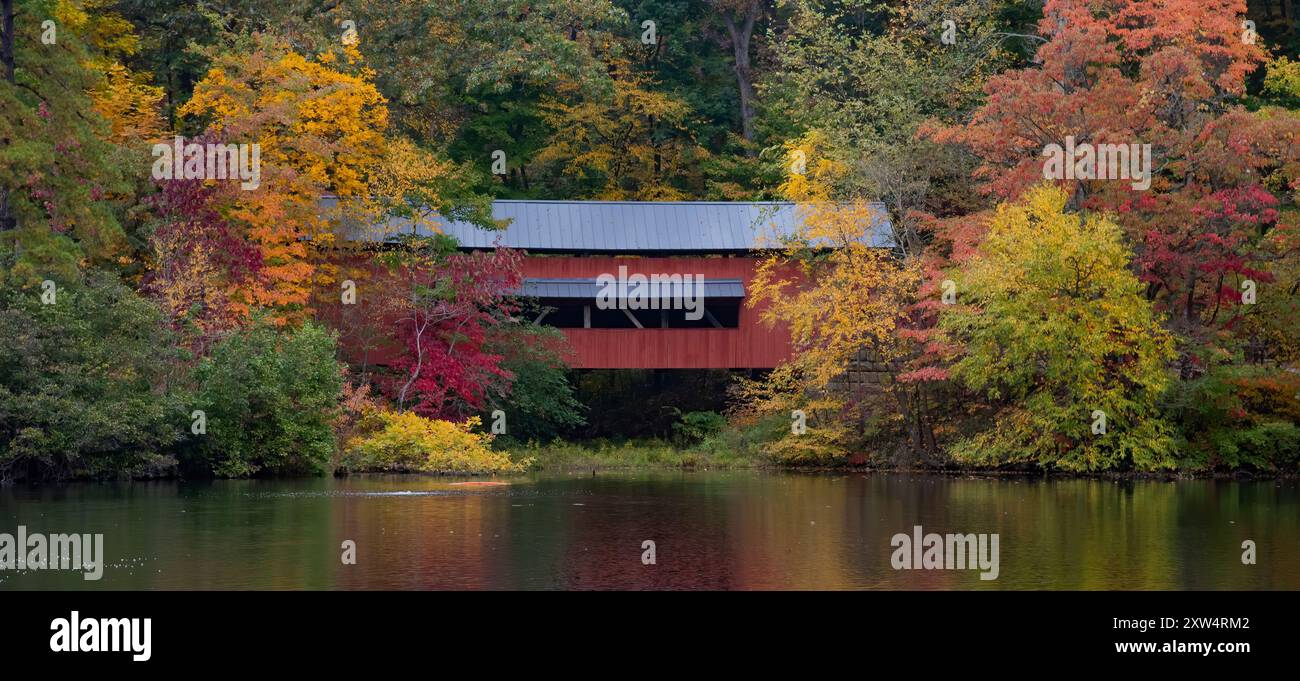 Autumn leaves surrounding covered bridge Stock Photo - Alamy