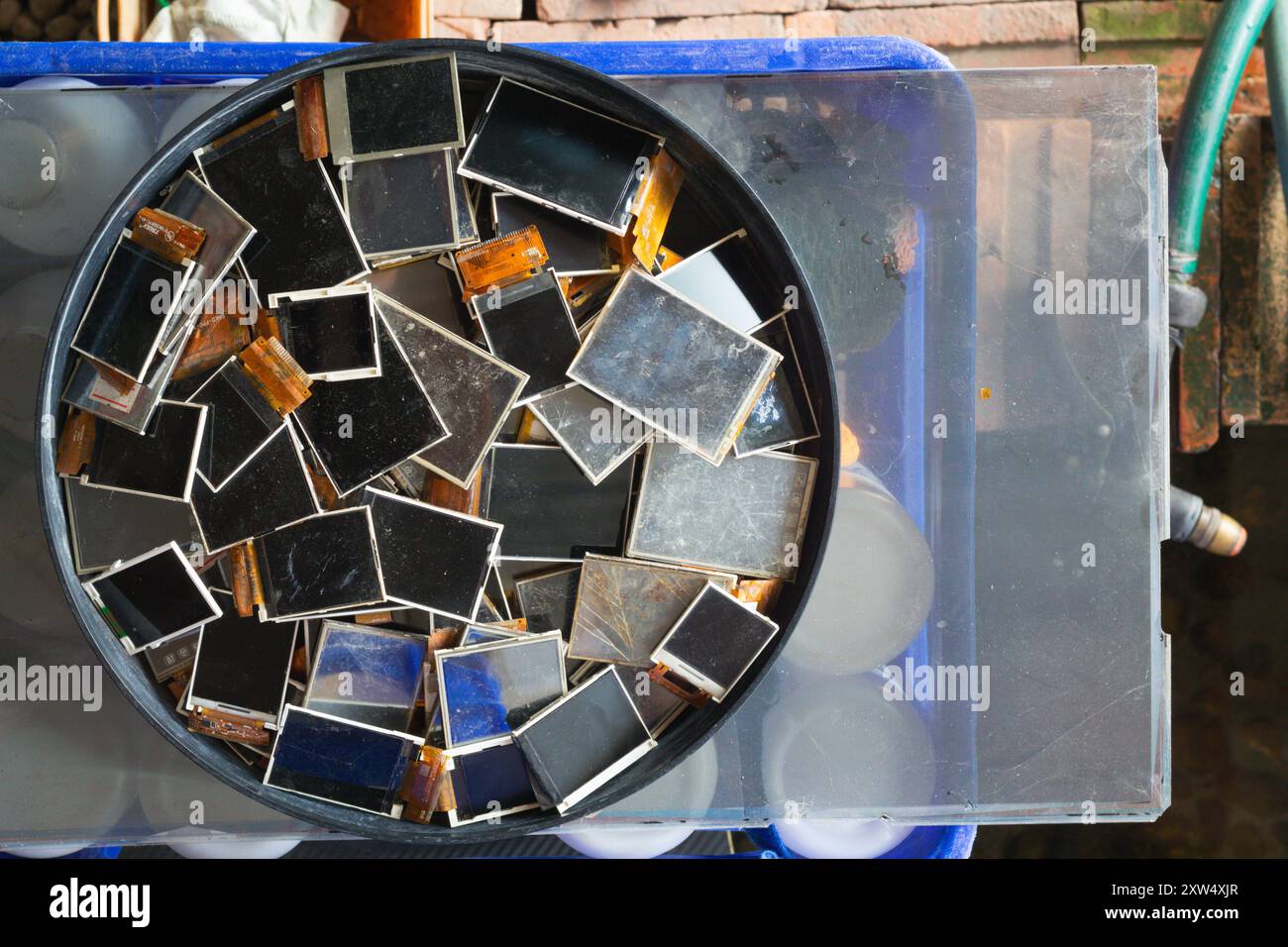 damaged LCD screens of mobile phones are collected as electronic waste ...