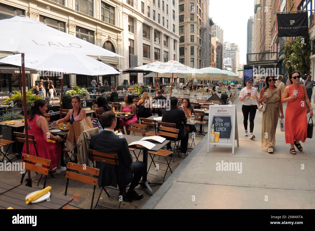 People sit at tables on Broadway in Manhattan, New York City Stock ...