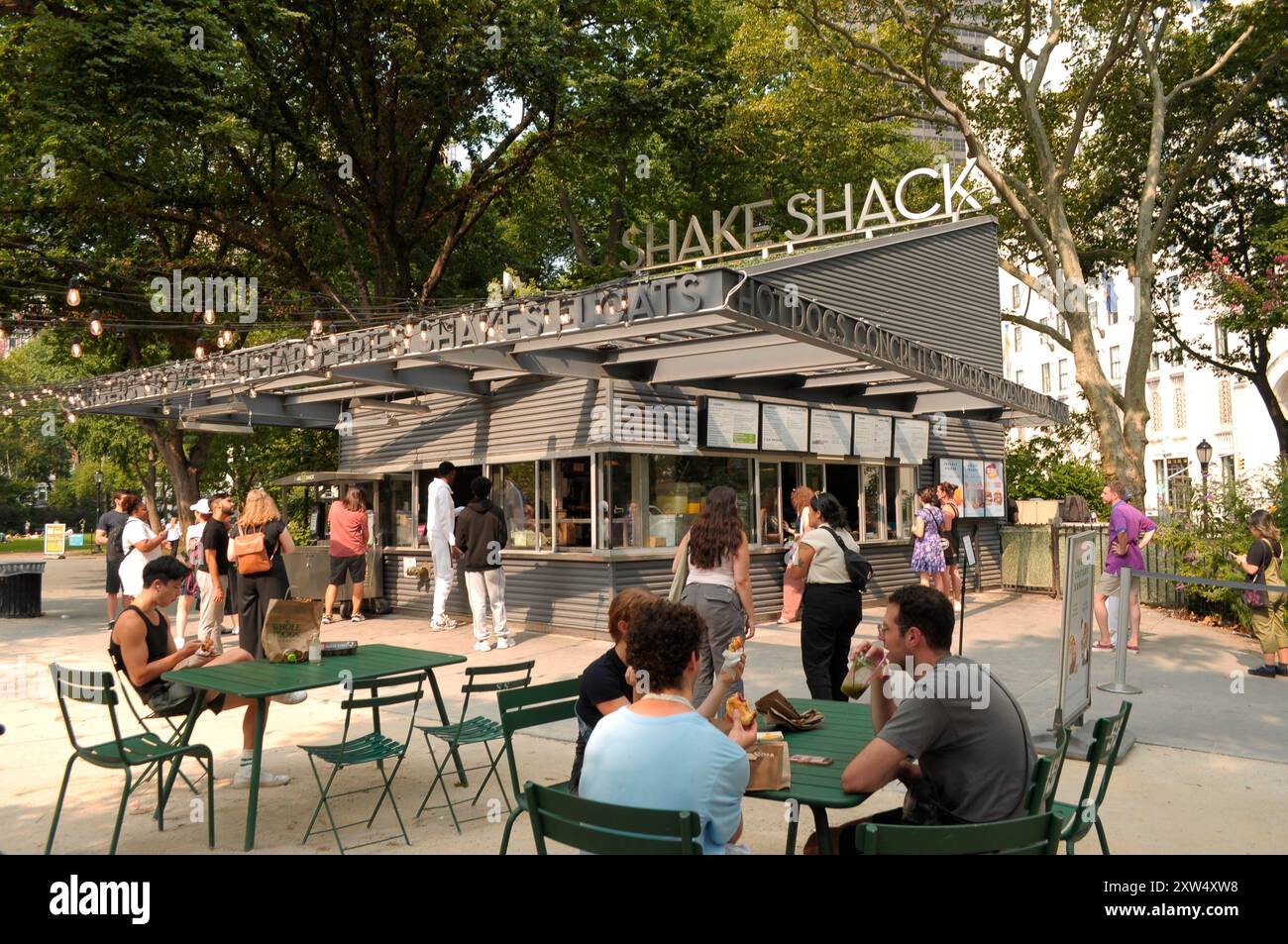 People sit at tables at a Shake Shack in Madison Square Park, Manhattan ...