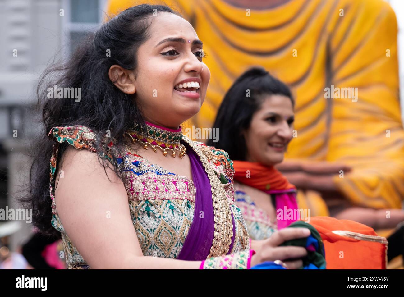 Belfast Mela Carnival Parade - a young Asian woman in beautiful ornate ...