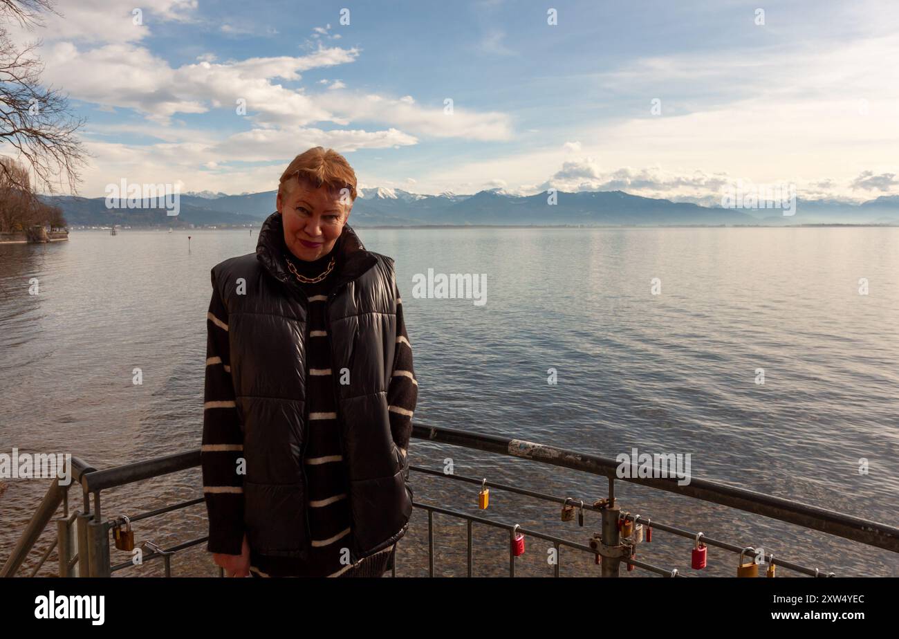 Smiling mature woman on the shore of Lake Constance. Early March Stock ...