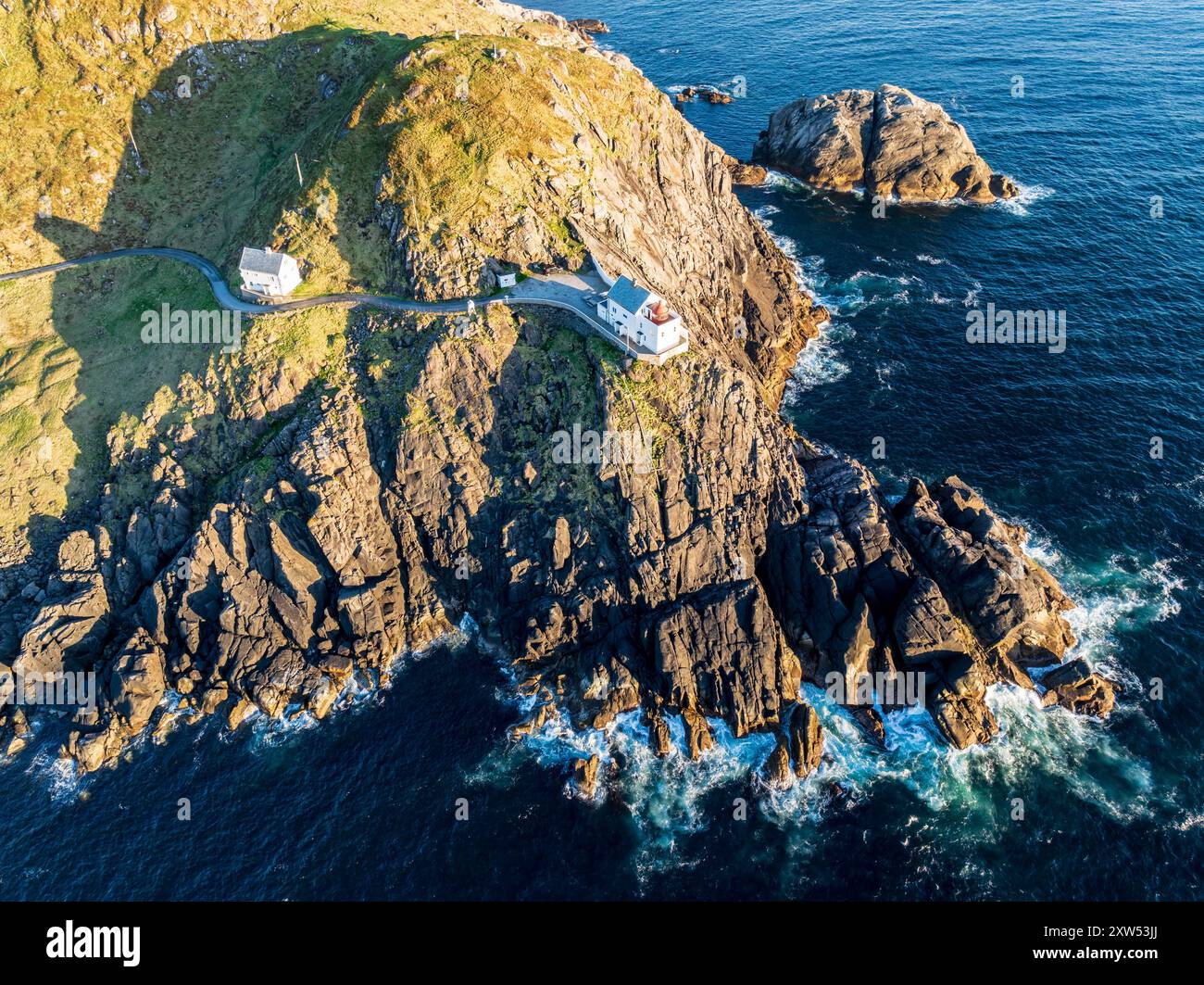 Aerial view of Krakenes Fyr lighthouse, lighthouse located on steep ...