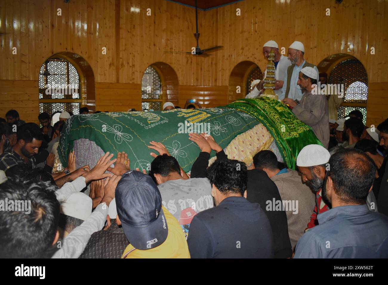 Srinagar, India. 17th Aug, 2024. Kashmiri Muslim men touch the sacred ...