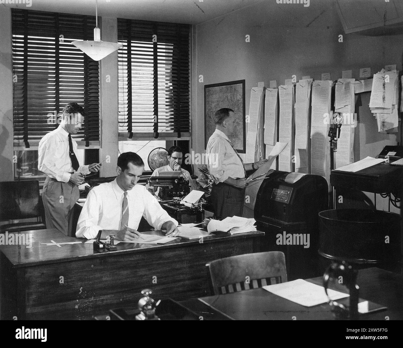 The teleprinter room in a large US broadcasting station. Here news from ...