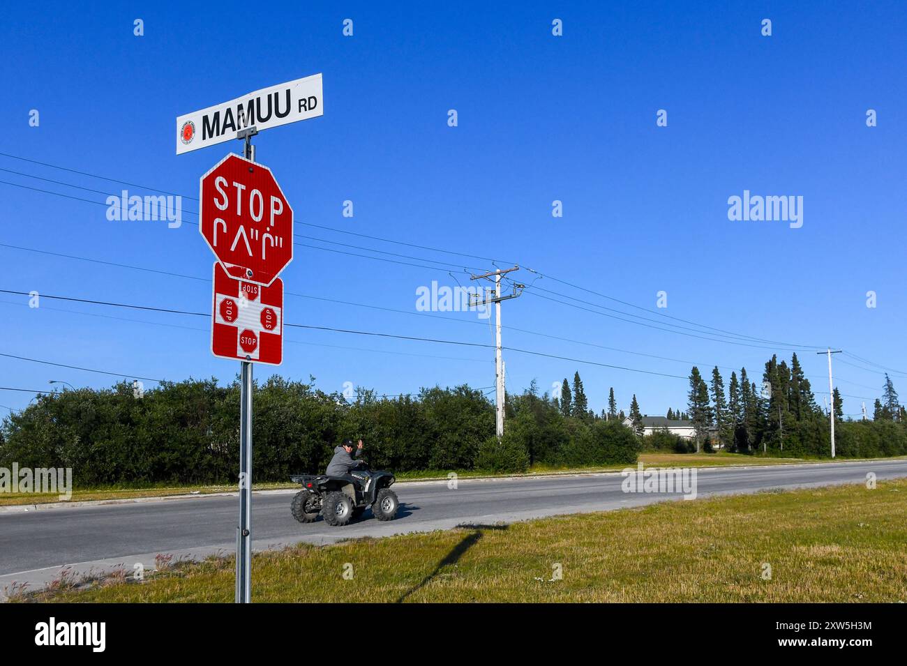 Stop sign with English and Indigenous languages in the Native community ...