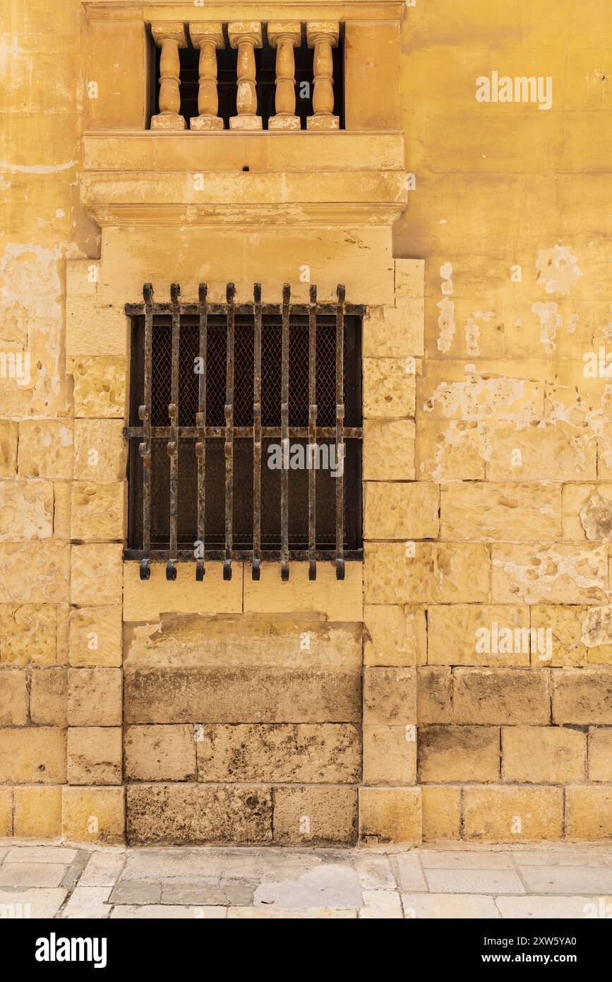 Malta, Mdina. Window with iron bars in a stone wall Stock Photo - Alamy