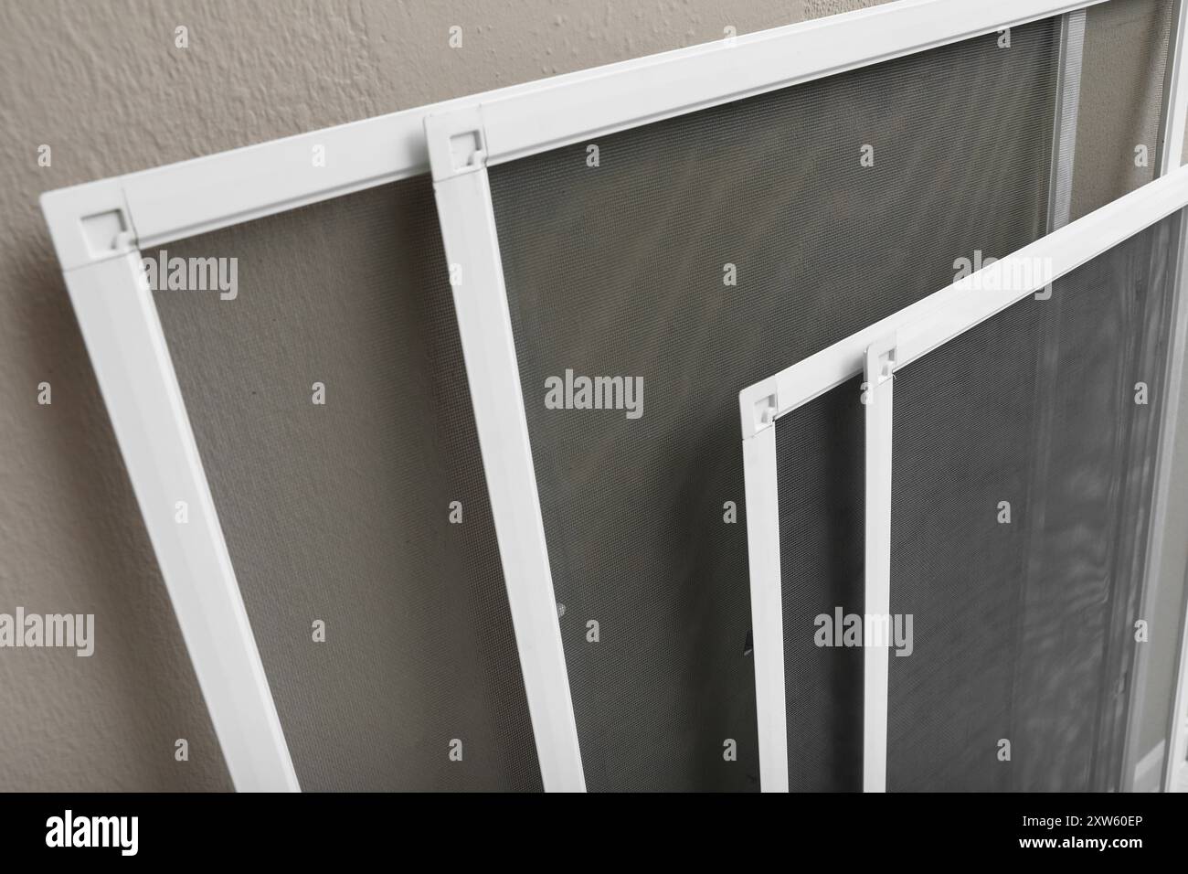 Set of window screens near beige wall, closeup Stock Photo - Alamy