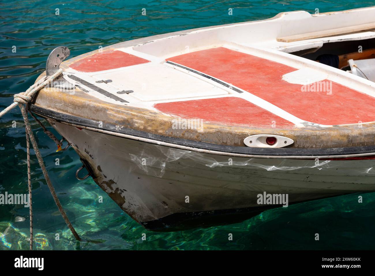 Bow of an old floating fishing boat. A fishing boat tied to a pier ...