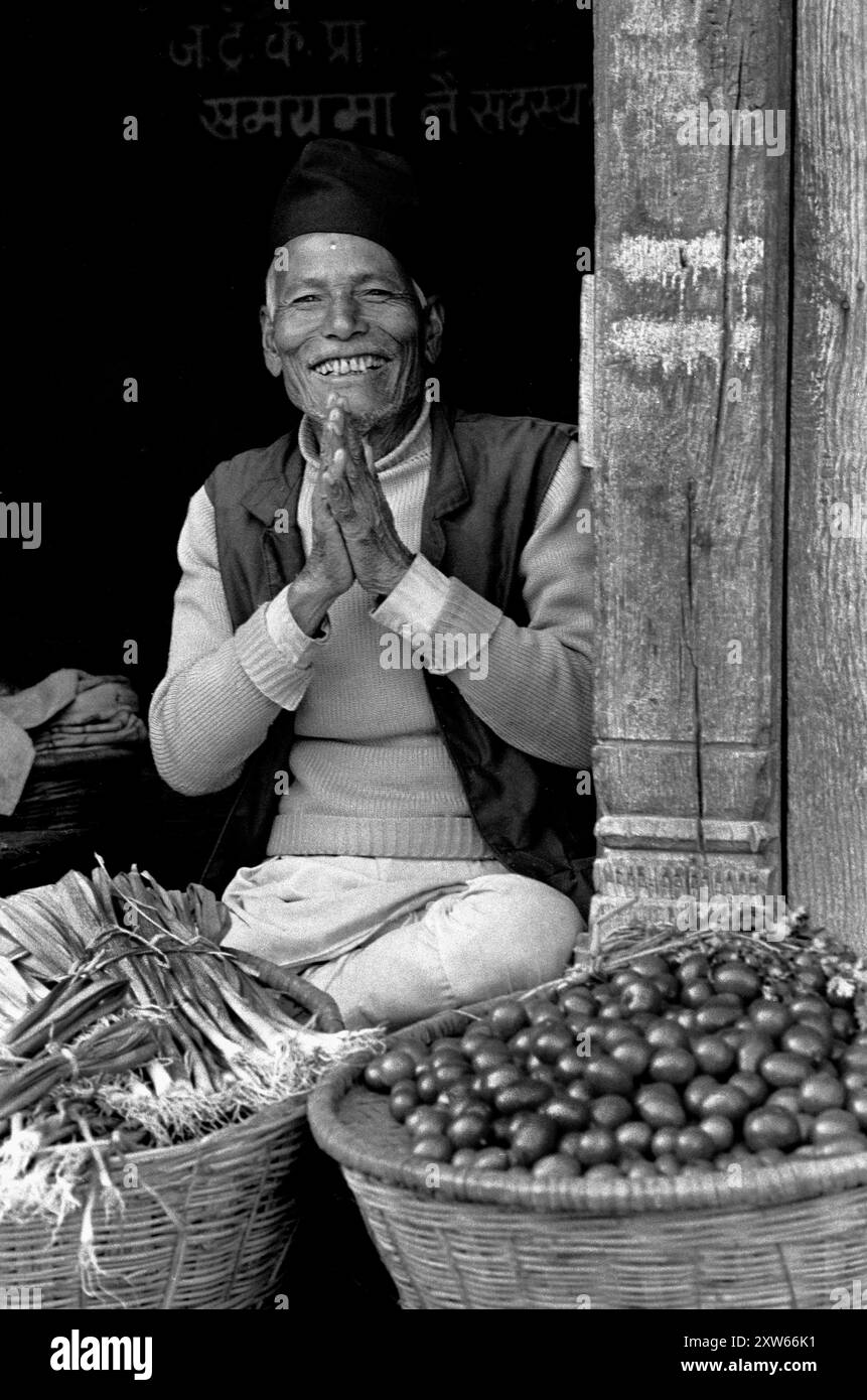 A soji or Nepali shop keeper smiles a namaste while selling his fresh ...