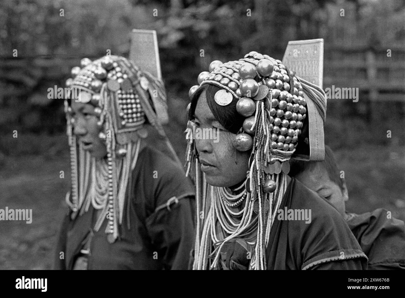 Woman of the Akha tribe wearing traditional headdresses of silver and ...