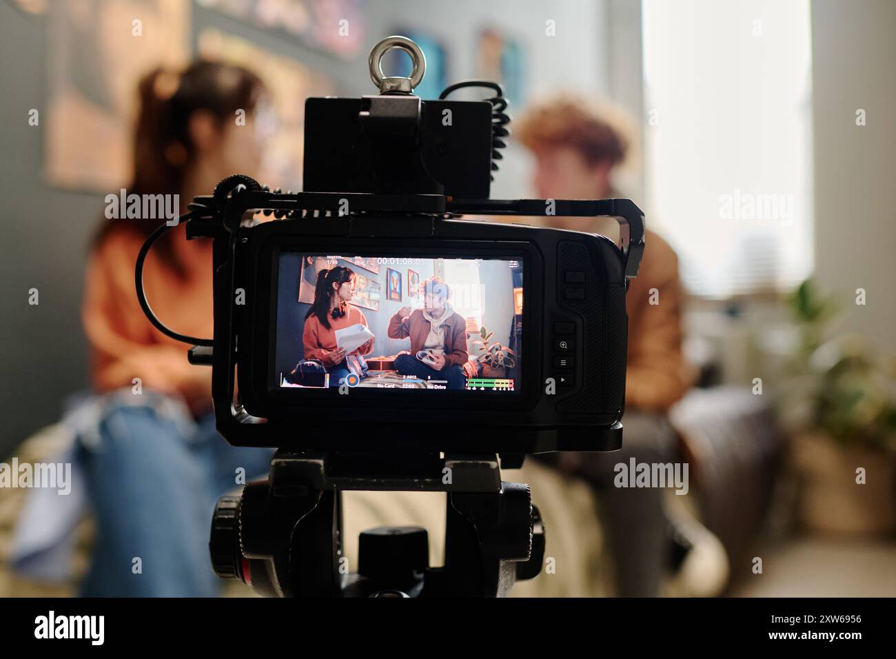 Two people sitting and engaging in conversation while professional ...