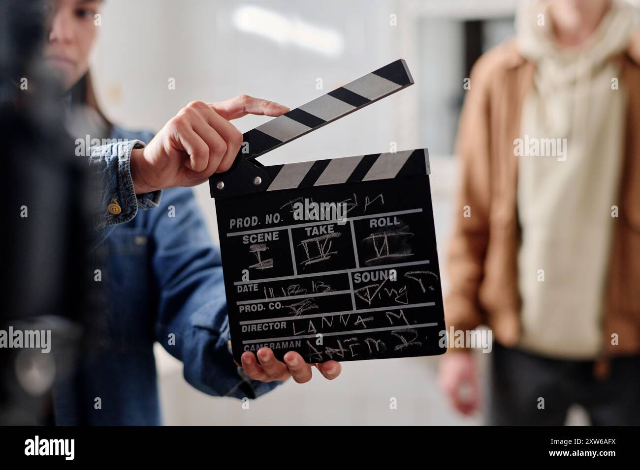 Crew member holding film clapper while preparing for a movie scene on a ...