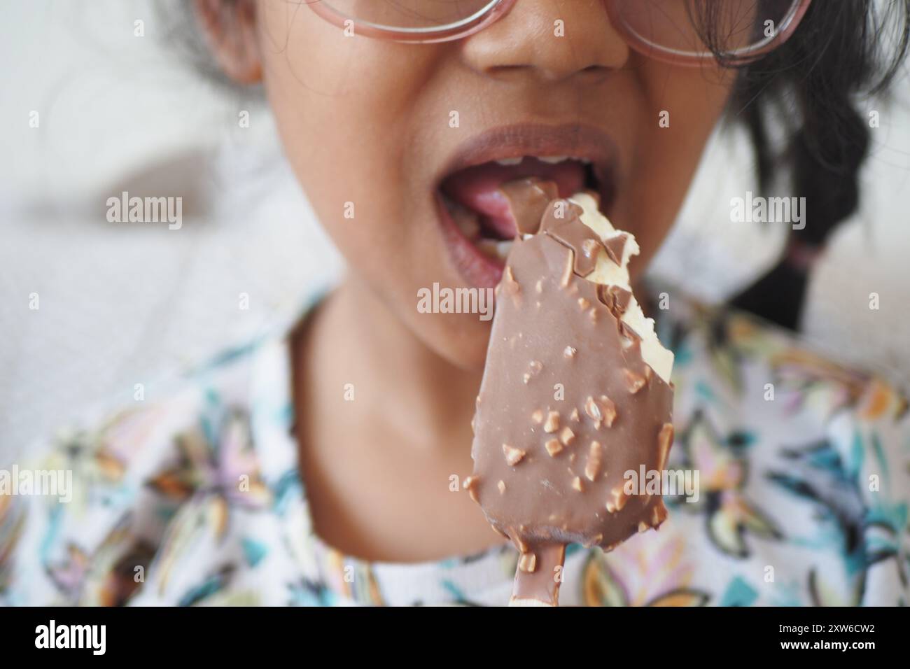 child happily eating an ice cream bar, exuding joy and enjoyment Stock ...