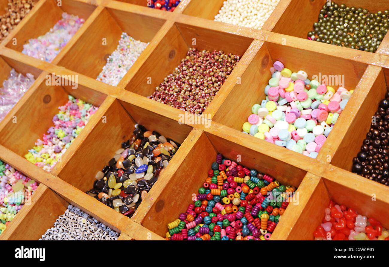 Variety of Colors and Shapes of Beads in Wooden Compartment Display ...