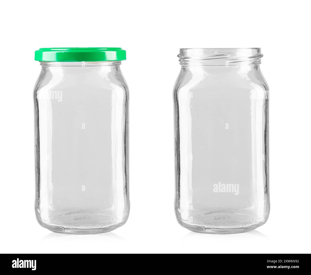 Two empty glass jars, one with a lid, one without. Isolated on a white ...