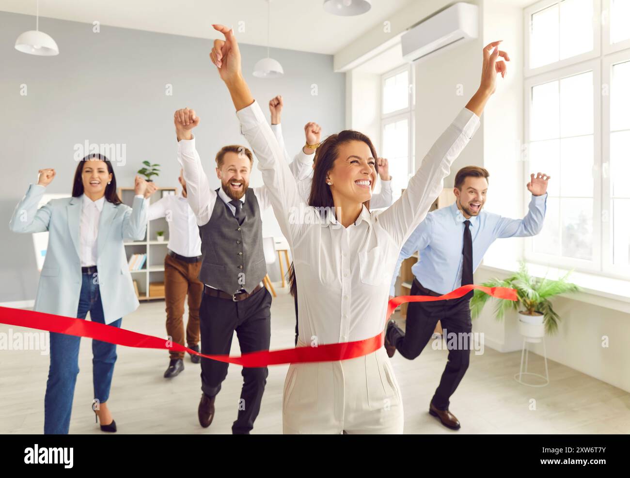 Businesswoman Crossing The Red Finish Line In Office Stock Photo - Alamy