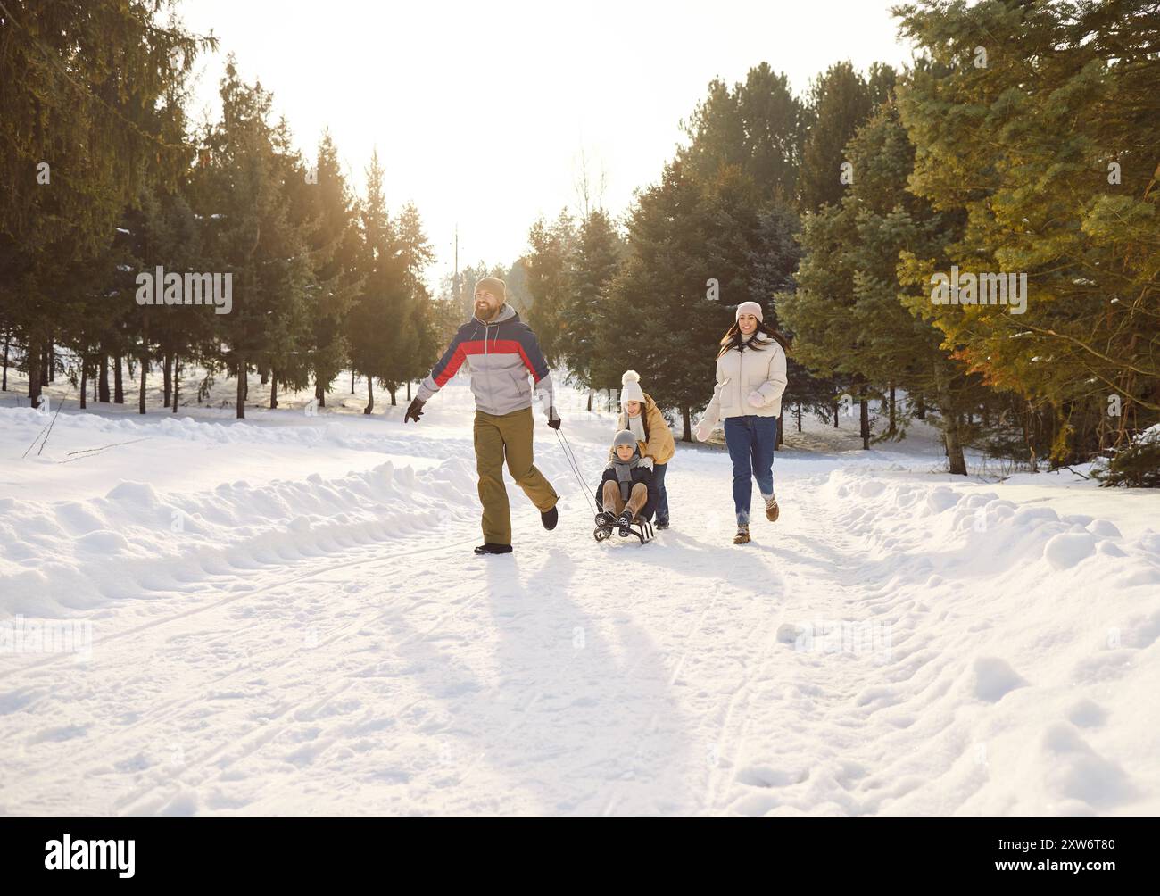Happy smiling family of four with two kids walking in winter park ...
