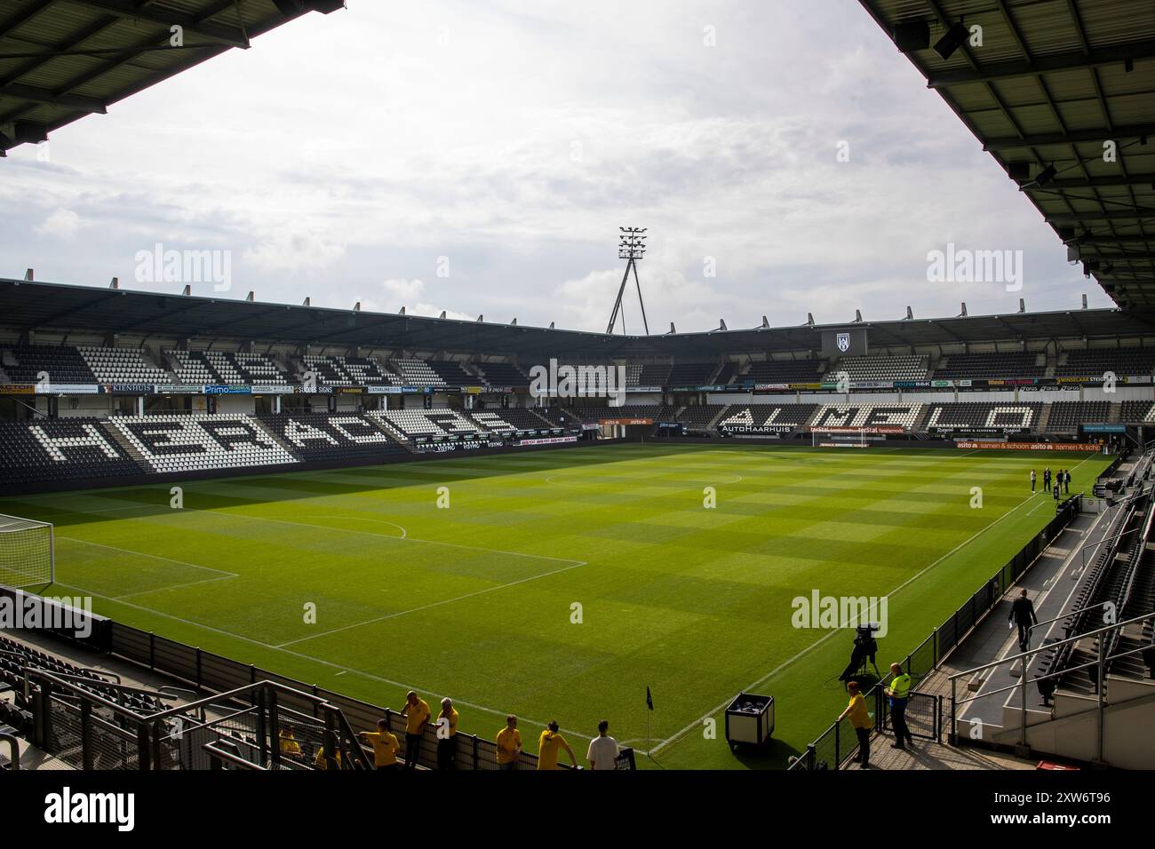 ALMELO - Interior of the stand with the grass pitch with name and logo ...