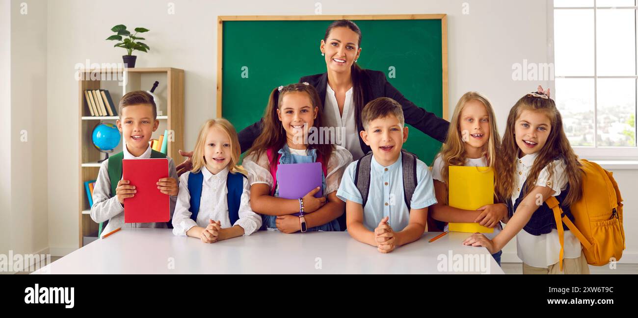 Portrait of female teacher and her little elementary school students on ...