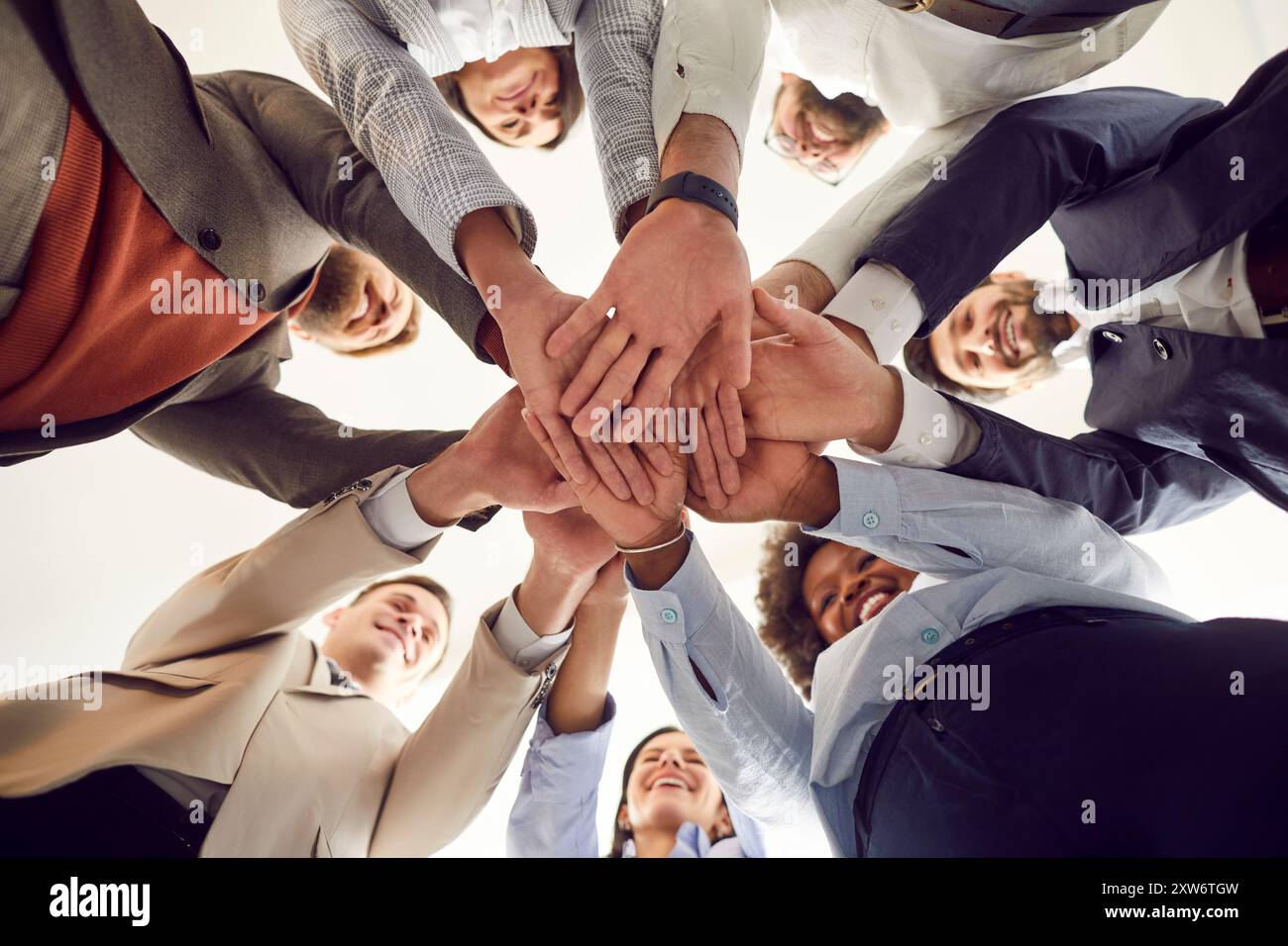 The team of diverse business people stack hands as a sign of teamwork ...