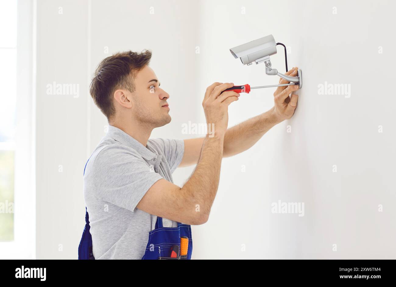 Cctv camera wall installation by professional male technician at wall ...