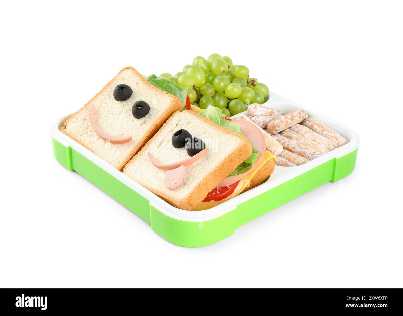 Sandwiches with smiley faces, grapes and cookies in lunch box isolated ...