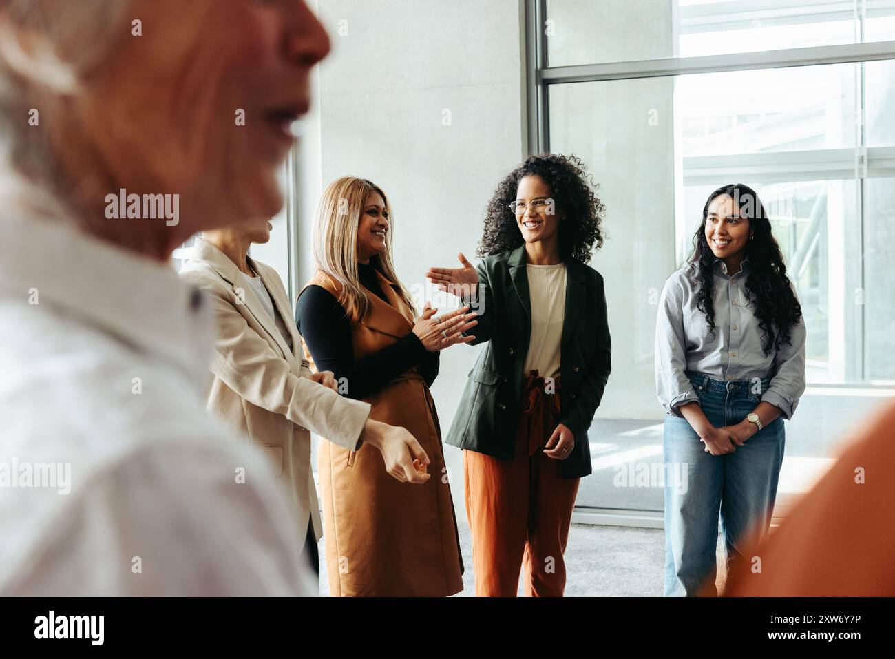 Diverse group of professionals interacting and sharing ideas at a ...