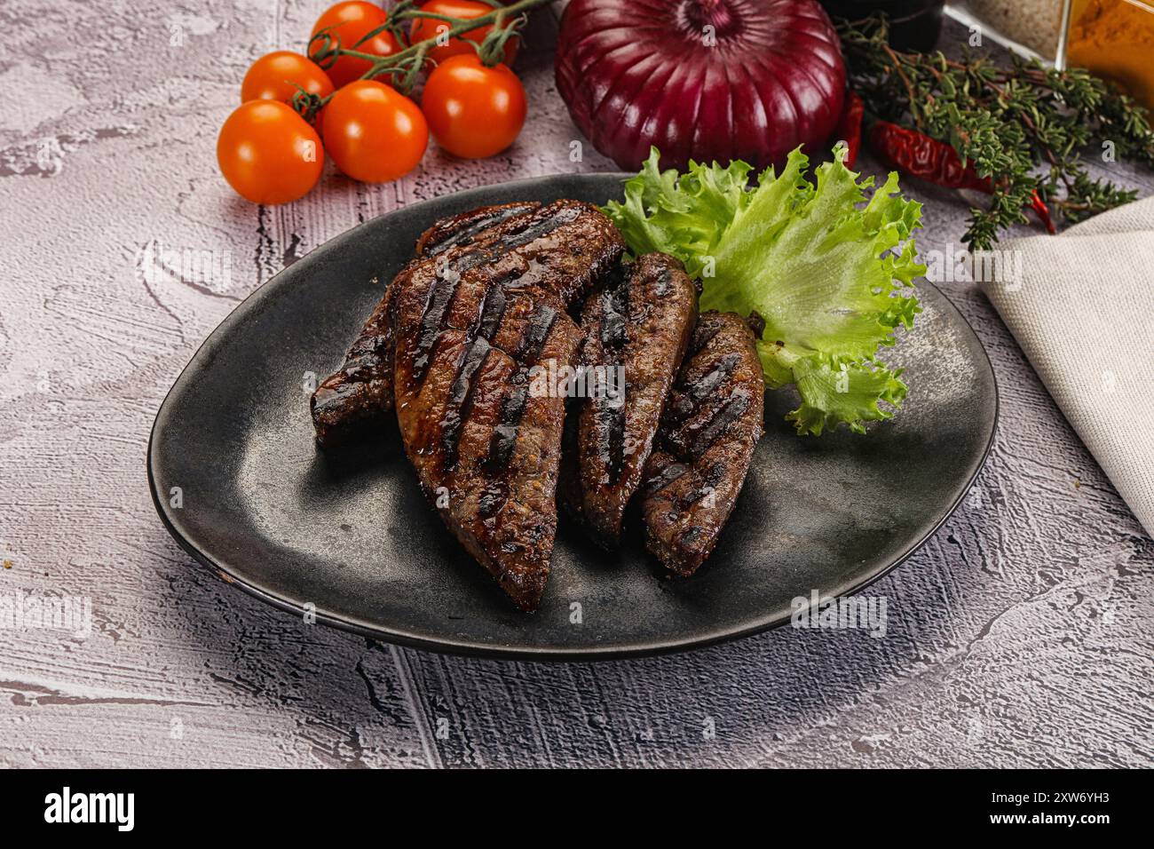 Grilled diet beef liver steak in the plate Stock Photo - Alamy