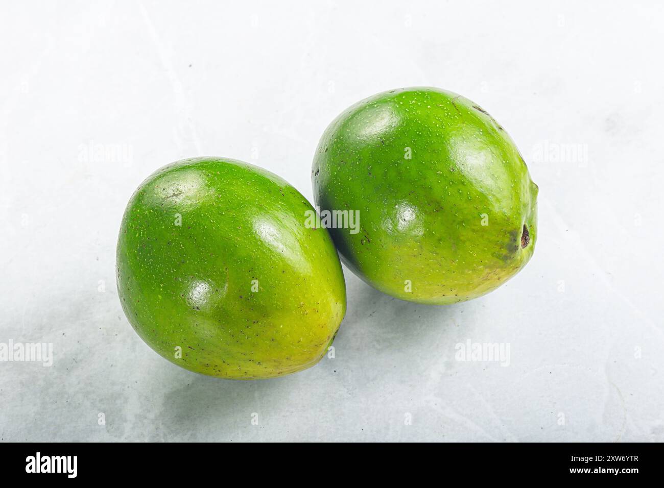 Two ripe green exotic avocado whole fruit Stock Photo - Alamy
