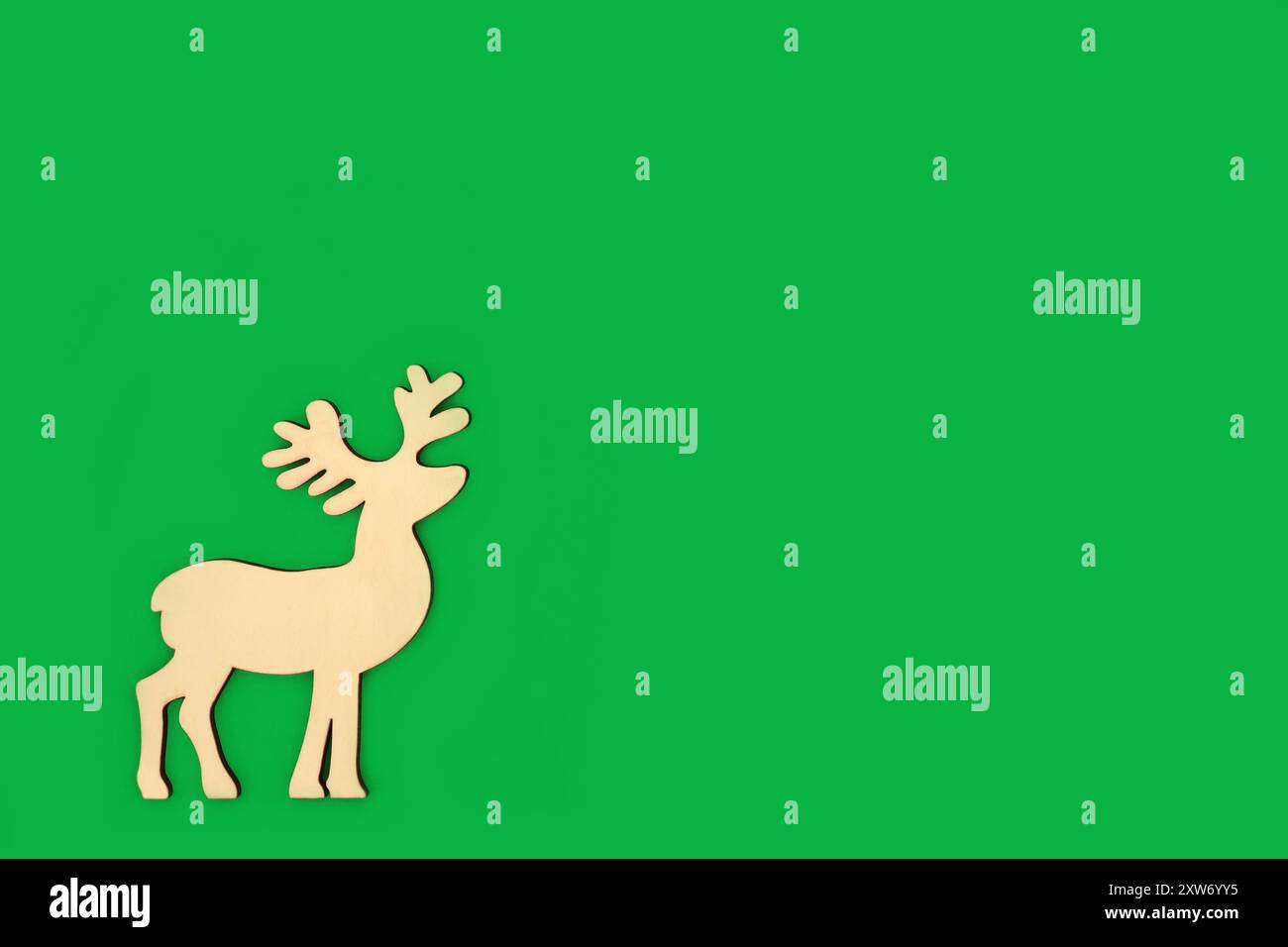 Natural wooden reindeer symbol of Christmas Eve, background on green ...